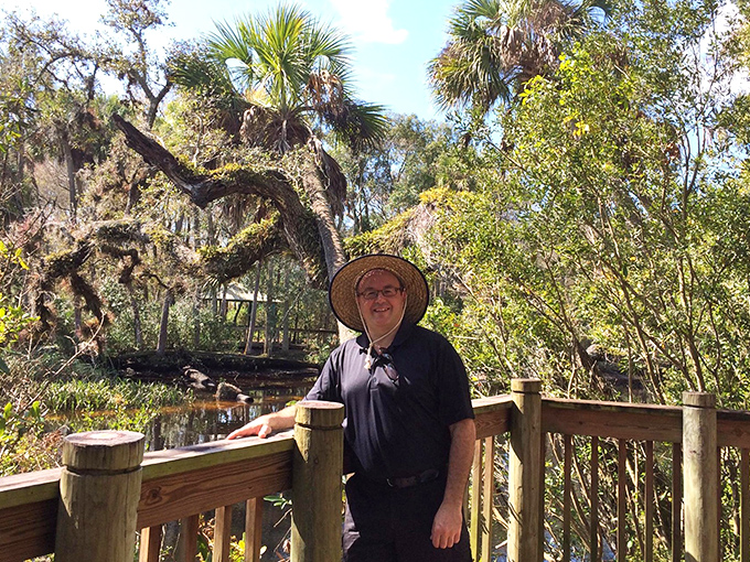 A visitor pauses to soak in the tranquil beauty &ndash; that hat isn't just fashion, it's essential Florida exploring equipment!