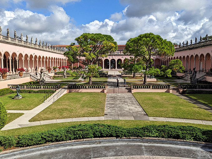 Pink colonnades stretch toward the horizon at The Ringling, creating a Renaissance dreamscape where classical sculptures find a Florida home.