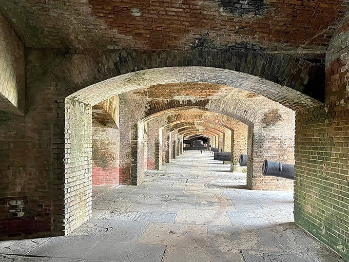 The fort's interior reveals a grassy parade ground surrounded by thick stone walls, offering visitors a peaceful place to connect with history.