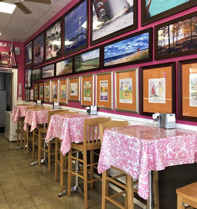 The warm, inviting interior of Pinkie's features pink tablecloths and walls adorned with local Michigan photography – the perfect backdrop for ice cream adventures.