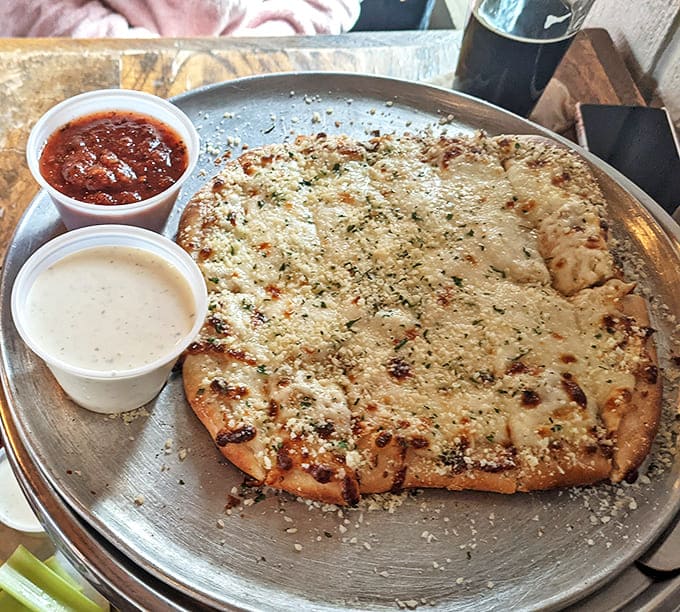 The garlic cheese flatbread proves Atwater's kitchen versatility, topped with generous parmesan and served with marinara and garlic cream sauces.