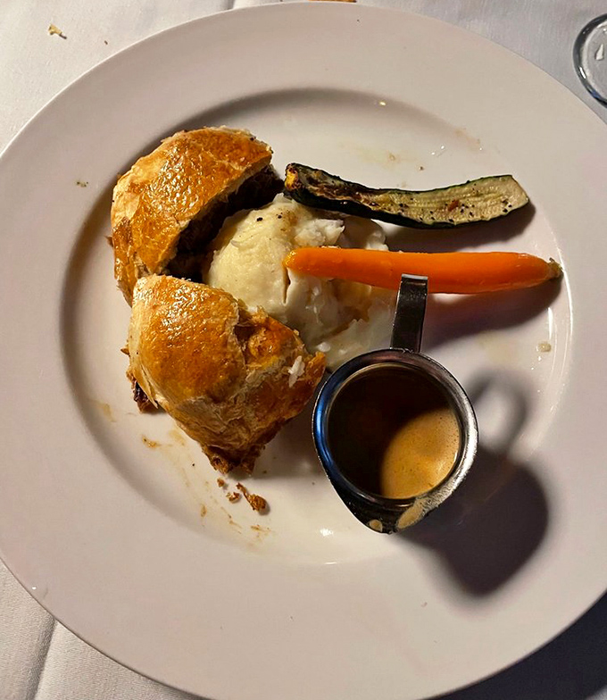 Golden puff pastry cradles a tender filet mignon, revealing layers of mushroom duxelles and creamy cheese when sliced into this classic showstopper.