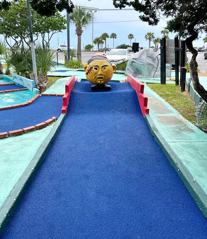 The mysterious blue ramp leads to a stern-faced statue that seems to judge your putting skills with ancient, unblinking eyes.