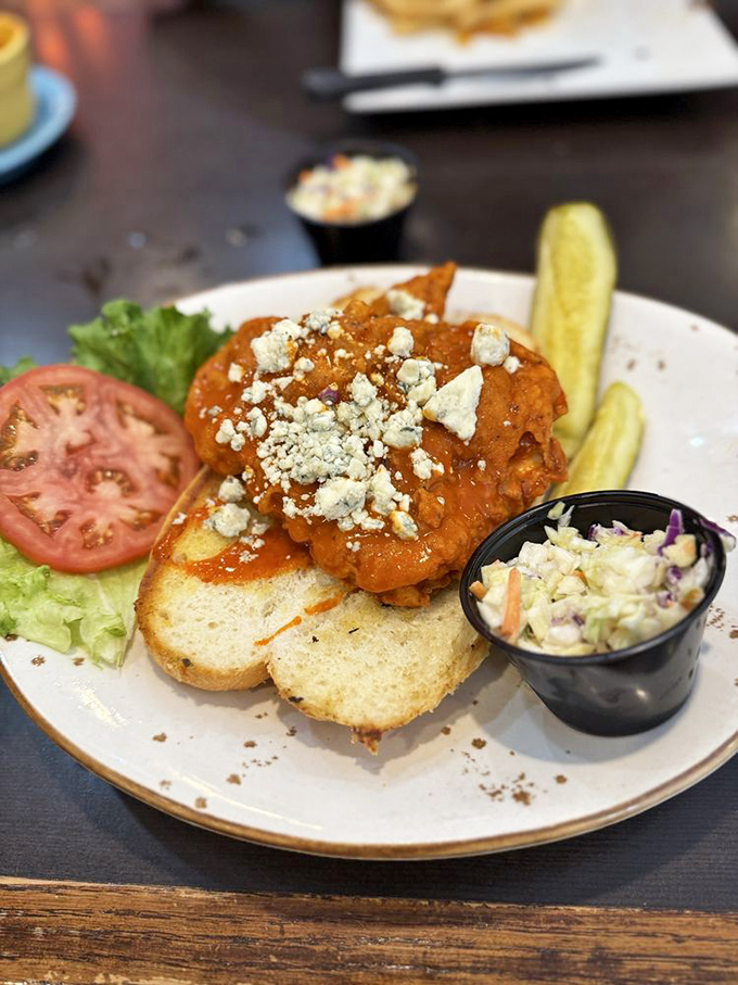 Buffalo chicken gets the royal treatment &ndash; crispy, saucy, and crowned with blue cheese crumbles that melt slightly into the warm chicken beneath.