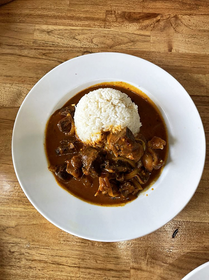 Curry goat that transforms the unfamiliar into the unforgettable &ndash; tender meat swimming in a sauce worth bottling and taking home.