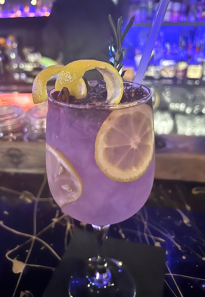 The Empress Gin & Tonic – where vibrant purple meets zesty lemon in a glass that's practically begging to be Instagrammed.