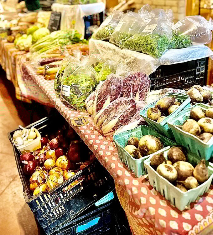 Nature's jewels arranged in rustic baskets – locally grown produce that connects shoppers to northern Michigan's agricultural bounty in a space once dedicated to therapeutic gardening.