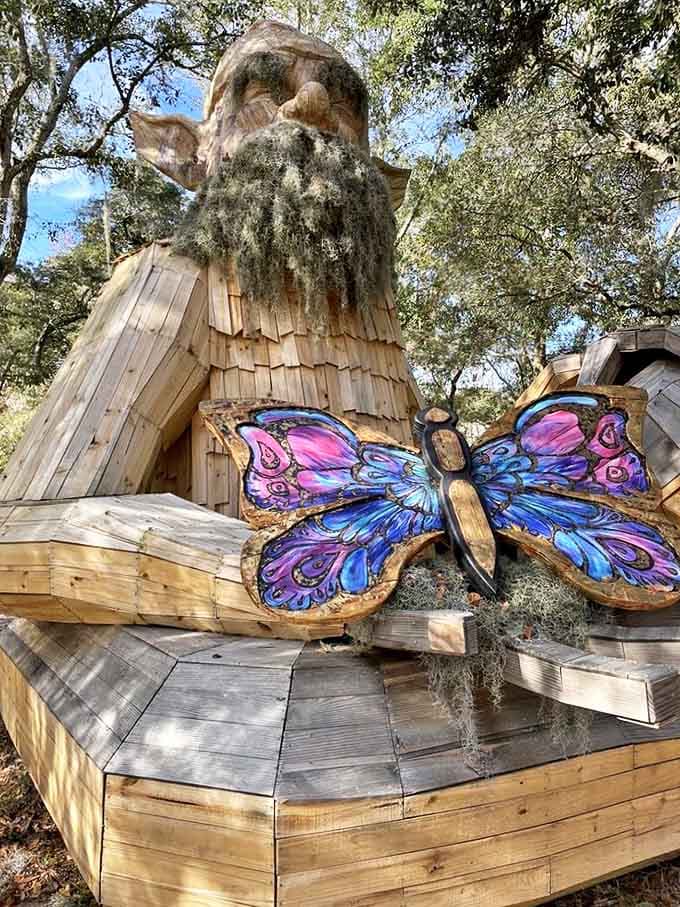 Up close with the woodland guardian, whose intricate wooden features and colorful butterfly companion create a magical focal point for wide-eyed visitors.