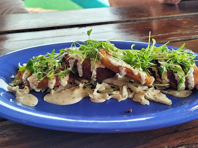Fried Green Tomatoes that would make any Southern grandmother proud, topped with crab cake and drizzled with remoulade sauce.