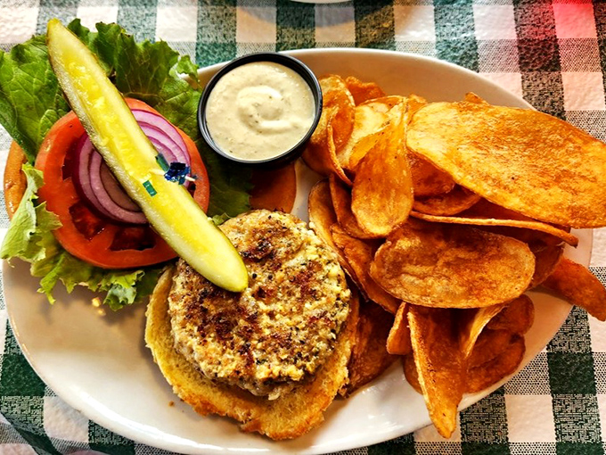 The legendary gator burger arrives with crispy chips and a pickle spear &ndash; a taste of Florida wilderness that won't bite back (unlike its namesake).
