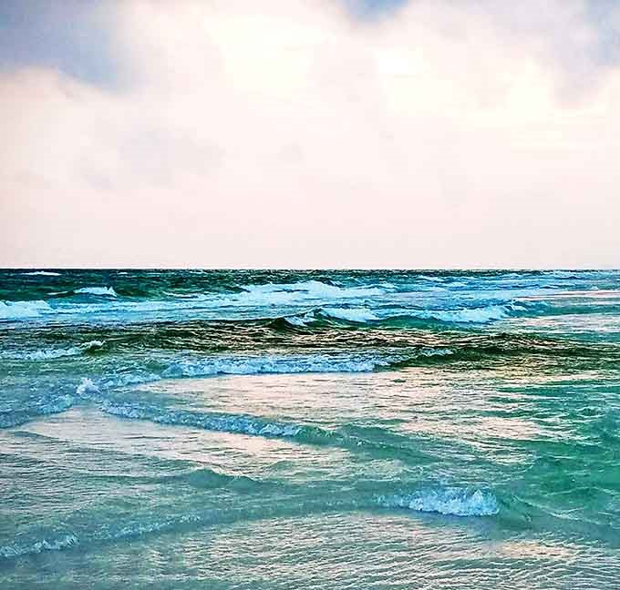 Emerald waves kiss the shoreline in a never-ending dance that hypnotizes visitors into a state of beach-induced bliss.