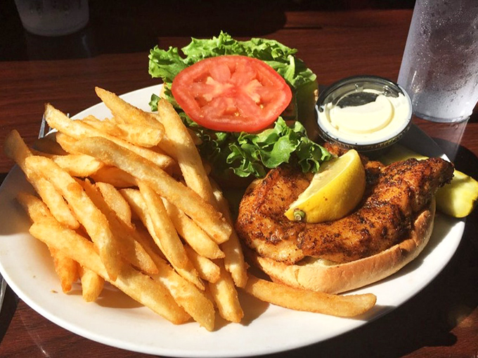 Golden fries flank a masterpiece of culinary simplicity &ndash; fresh grouper on a soft bun with crisp veggies that somehow tastes like Key West sunshine in sandwich form.