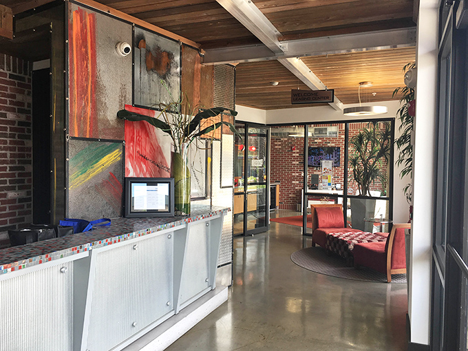 The reception area blends industrial chic with artistic flair – like if Willy Wonka opened a welding shop instead of a chocolate factory.