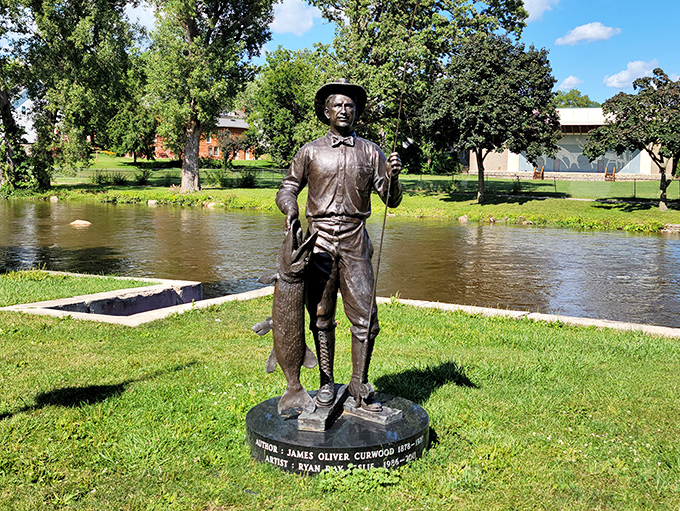 Forever fishing for inspiration, this bronze statue of James Oliver Curwood keeps eternal watch over his beloved Shiawassee River.