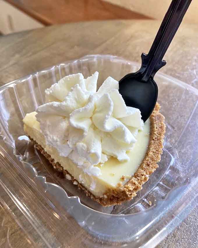 A slice of Key Lime heaven with that signature crown of whipped cream &ndash; the kind that makes you momentarily forget your own name.