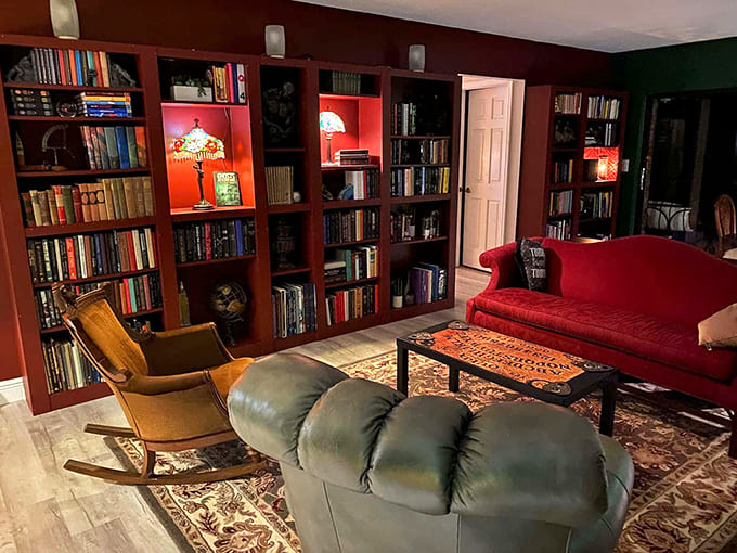 The library room offers literary frights and comfortable seating. Nothing says "cozy horror" like reading Poe surrounded by vintage collectibles.