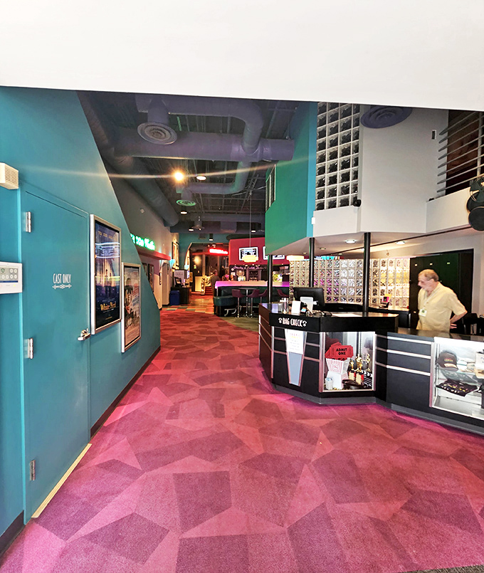 Geometric patterns and bold colors dance across the lobby floor, setting the stage for the cinematic adventures that await.
