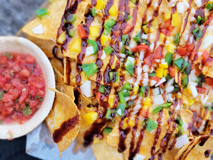 A mountain of technicolor toppings cascades over crispy chips &ndash; proof that sometimes the messiest foods are the most beautiful.