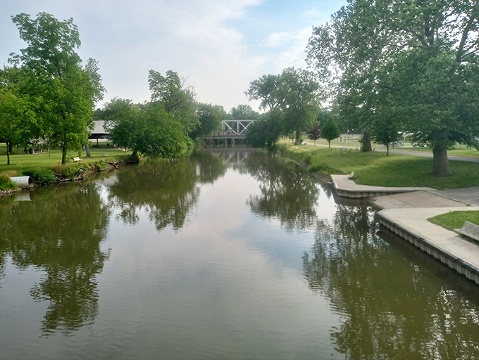 O'Mara Park's serene waterway reflects both clouds and the slower pace that makes Blissfield the perfect escape from big-city chaos.