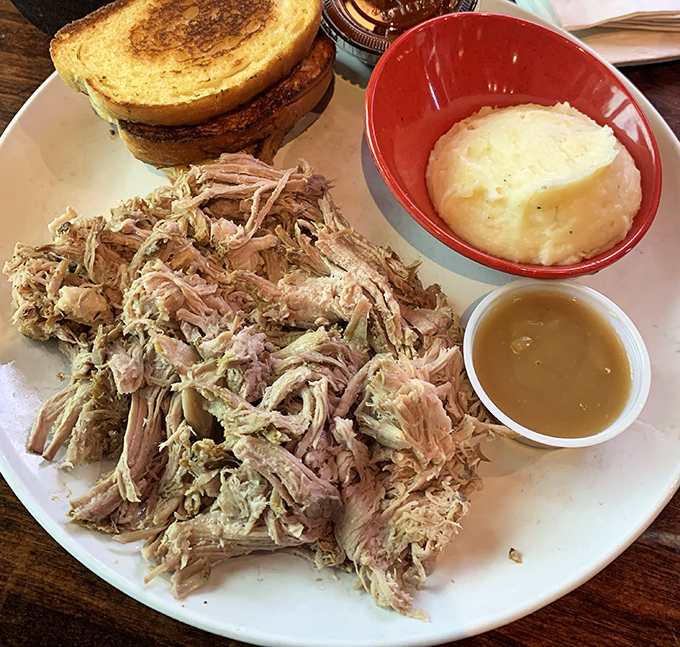 Pulled pork piled high with Texas toast and creamy sides – comfort food that hits all the right notes without trying too hard.