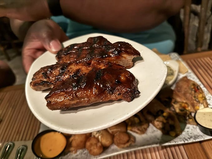 These glistening ribs aren't just fall-off-the-bone tender; they're the kind that make you consider licking your fingers in public without shame.