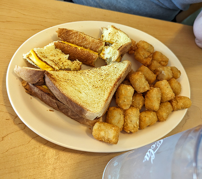 Golden-brown tater tots surround a perfectly grilled sandwich&mdash;proof that simple pleasures are often the most satisfying. Comfort food elevated to an art form.