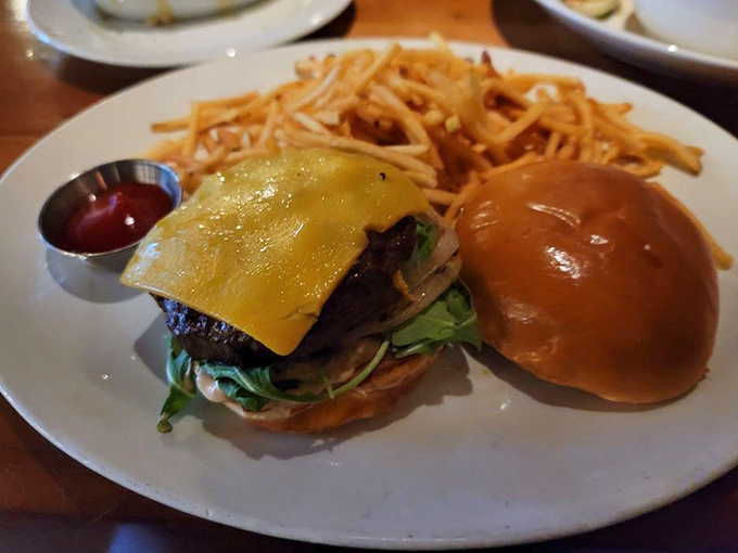 This isn't just a burger, it's architecture &ndash; a towering testament to beef brilliance with cheese cascading down like a yellow waterfall of deliciousness.