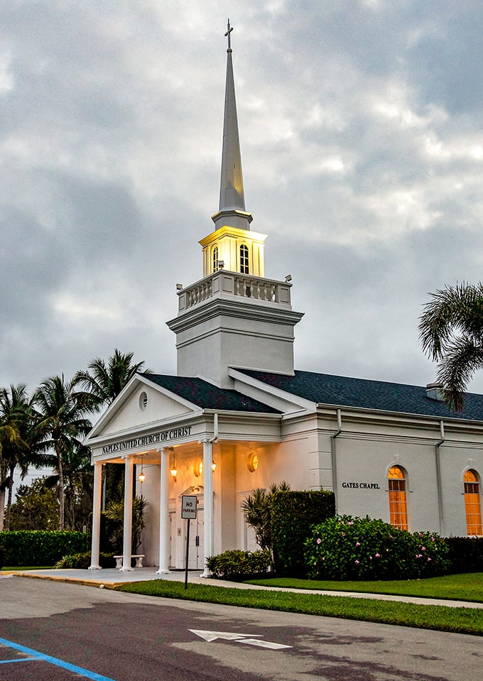 Naples United Church of Christ's gleaming white fa&ccedil;ade and soaring steeple create a striking landmark against the tropical blue sky.