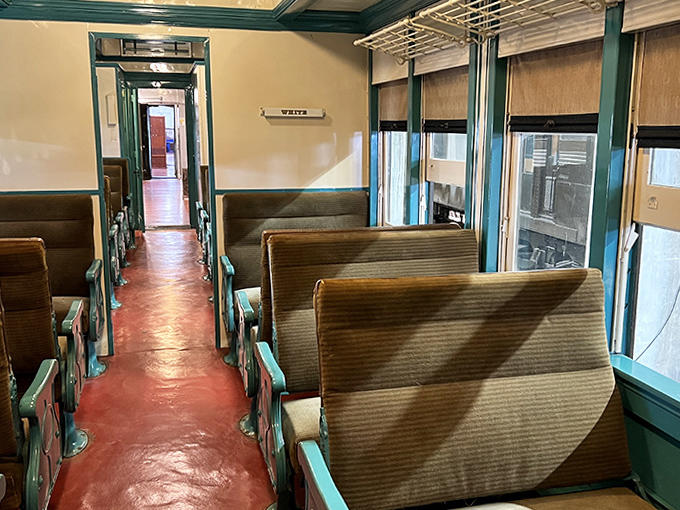 Those wooden benches have supported generations of passengers, each one watching America scroll past like the world's longest scenic movie.