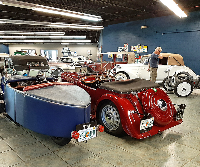 A visitor admires the mechanical poetry of these vintage treasures, surrounded by history that purrs with potential energy.
