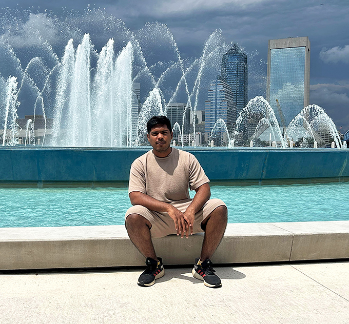 A visitor enjoys the perfect vantage point for Jacksonville's most mesmerizing water display, finding a moment of tranquility amid urban energy.