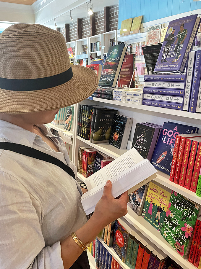 Lost in the pages of a potential purchase, this visitor demonstrates the shop's true purpose: creating moments of connection between readers and stories.