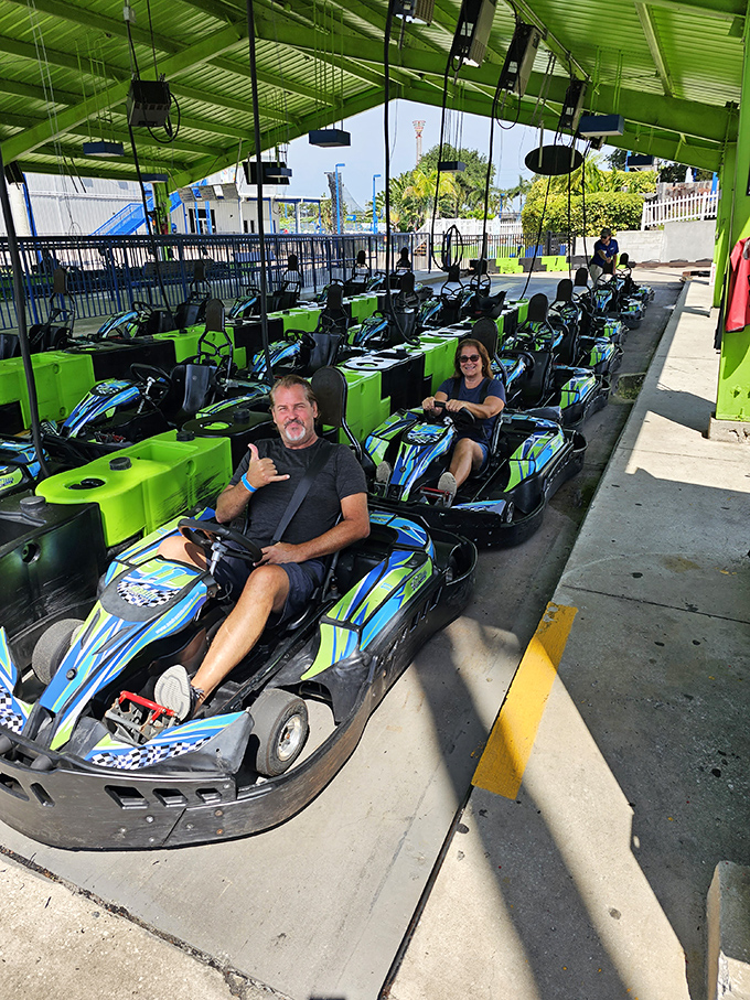 Racers give thumbs up from their go-karts, the universal signal that says "I'm about to leave you in my dust!"
