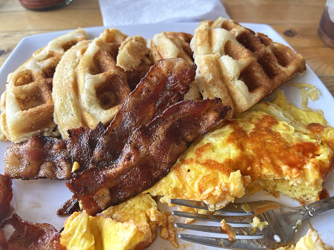 Morning glory on a plate: golden waffles, perfectly cooked eggs, and bacon that hits the sweet spot between crispy and chewy.