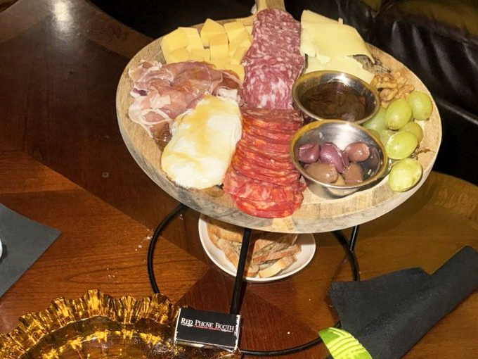 A charcuterie board that's practically a work of art, featuring select meats and cheeses that pair perfectly with your handcrafted cocktail.