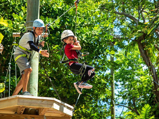 Childhood dreams realized! A young adventurer takes flight with a watchful guide, creating memories that will outlast any theme park visit.