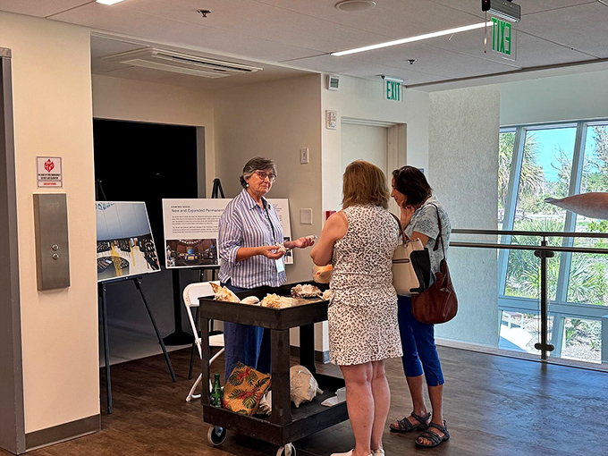Knowledge-hungry visitors engage with a museum educator, proving that the best souvenirs from any trip are the fascinating stories you take home.