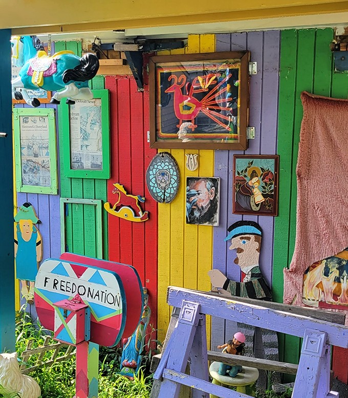 Every inch of wall space becomes a gallery, with framed artwork competing for attention against the rainbow backdrop of wooden planks.