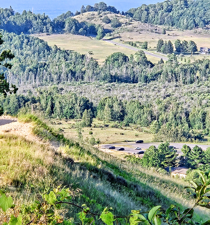 Rolling hills and forests create a patchwork quilt of Michigan wilderness, with glimpses of civilization tucked into valleys.