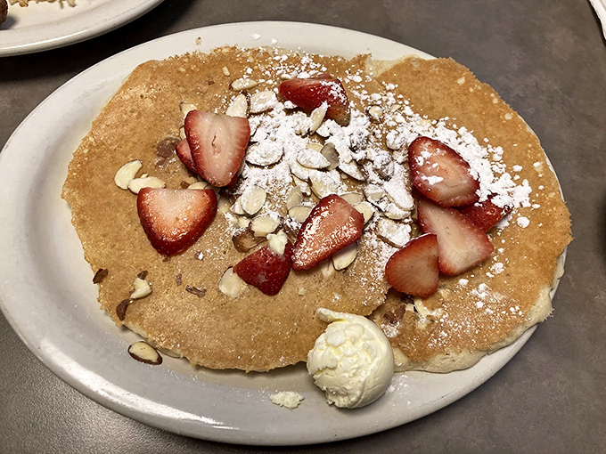 Pancakes that would make even Ringo drum with delight &ndash; topped with fresh strawberries, almonds, and a dollop of whipped cream that melts into pure breakfast bliss.