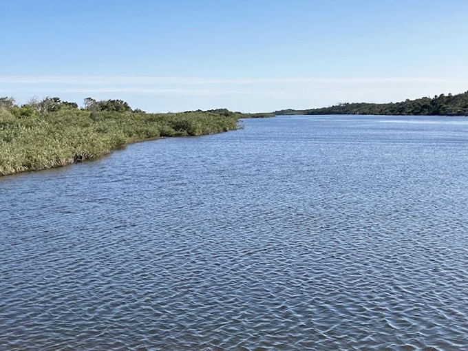 The Intracoastal Waterway gleams like liquid silver, a natural highway where only ripples mark the passage of time.