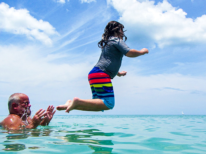 Family joy captured mid-splash &ndash; where memories are made one cannonball at a time in the Gulf's gentle waters.