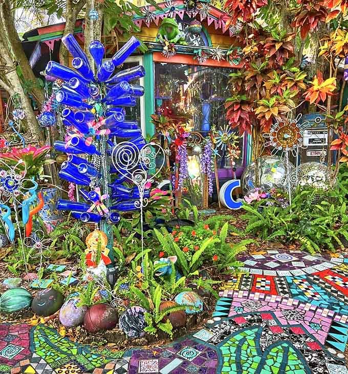 Blue bottle sculptures catch Florida sunlight like sapphire fireworks frozen in mid-explosion, turning recycled glass into garden magic.