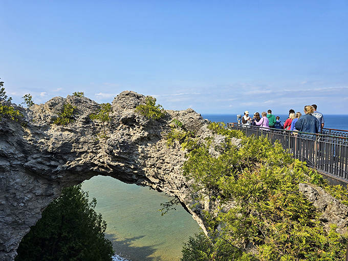 Tourists gather at the viewing platform, their expressions of awe nearly as timeless as the formation they've come to admire.