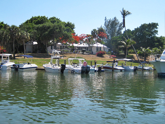 The marina welcomes seafaring visitors with the promise of legendary cheeseburgers and dollar-bill wallpaper just steps away from their moorings.