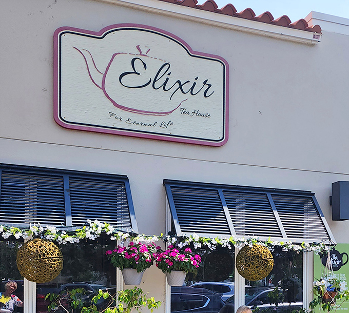 Elixir Tea House's crisp white facade with Mediterranean blue accents promises magical brews and a touch of European charm.