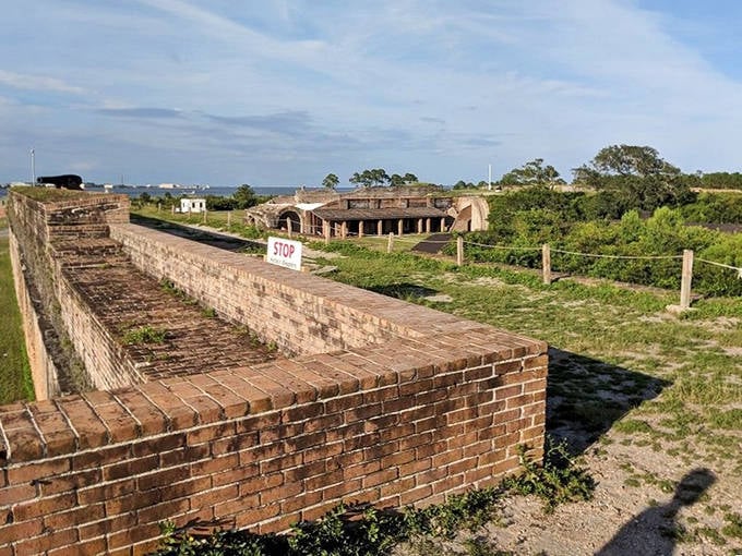 The fort's strategic waterfront location offers both historical significance and natural beauty, with the flag flying proudly above its weathered walls.