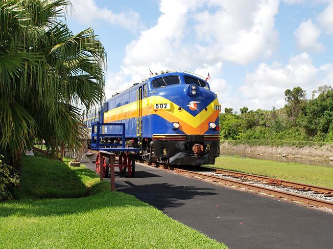The vintage blue and yellow locomotive of the Murder Mystery Dinner Train awaits passengers for a journey of dining and detection.
