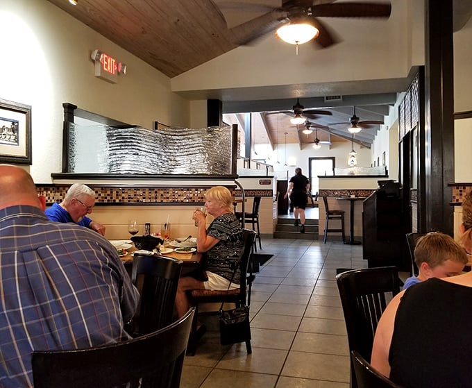 Guppy&rsquo;s dining area features warm wood paneling that creates a cozy nautical vibe, adding a touch of seaside charm to every meal.