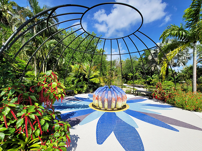 Inside this domed sanctuary, a brilliant blue flower sculpture blooms eternally, framed by a perfect circle of sky above.